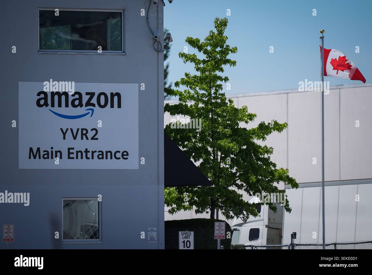 A Canadian flag flies outside Amazon's YVR2 fulfillment centre, in ...