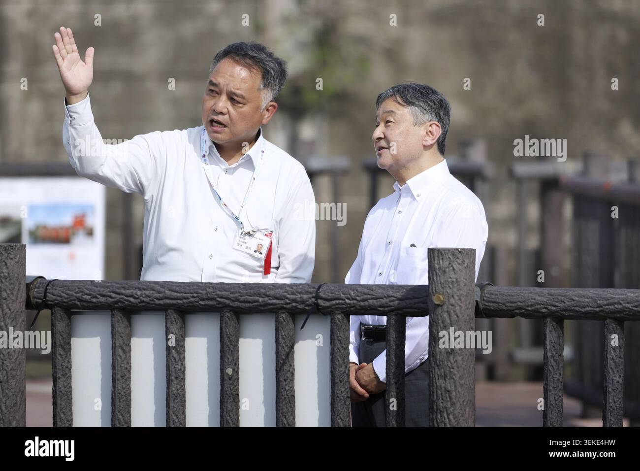 Japanese Emperor Naruhito (R) is briefed during a visit to a floodgate ...