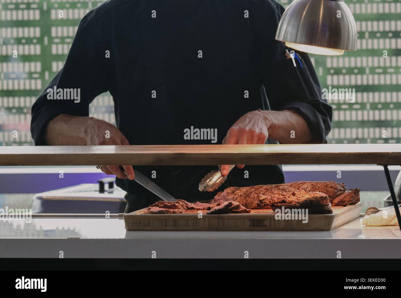 Chef Carving Juicy Roast Meat in a Bright, Modern Kitchen Environment ...