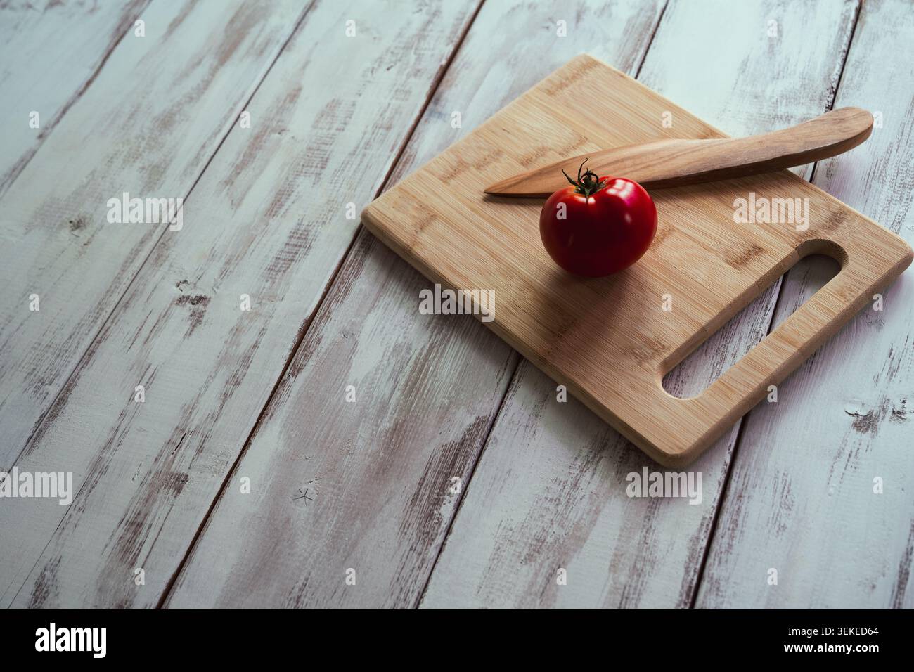 Fresh Tomato and Wooden Knife on Cutting Board in Rustic Kitchen Stock ...