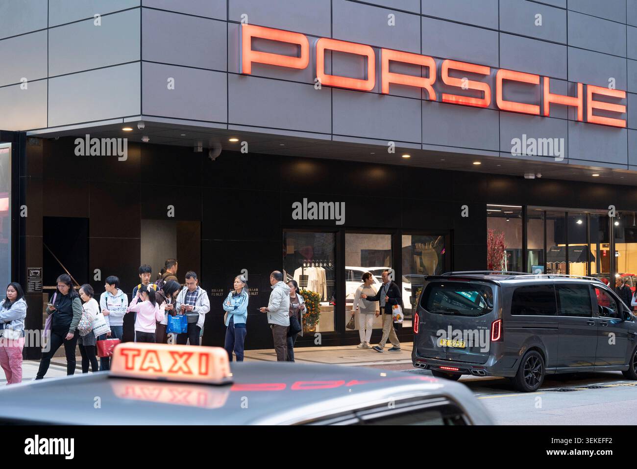 Pedestrians stand outside a dealership showroom of the German luxury ...