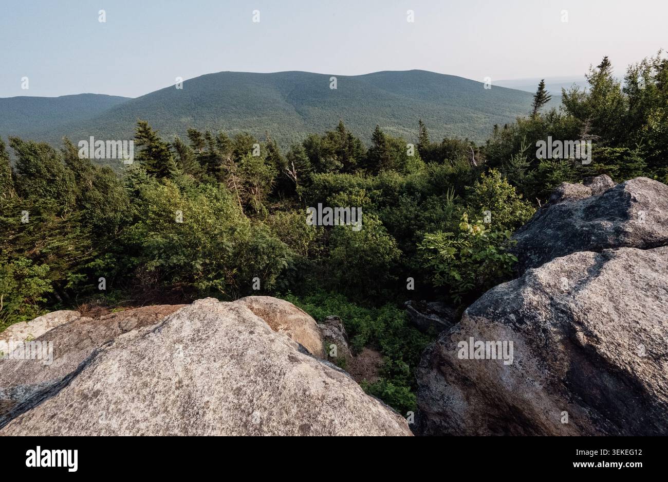 Vast Green Valley Surrounded by Mountains under a Blue Sky Stock Photo ...