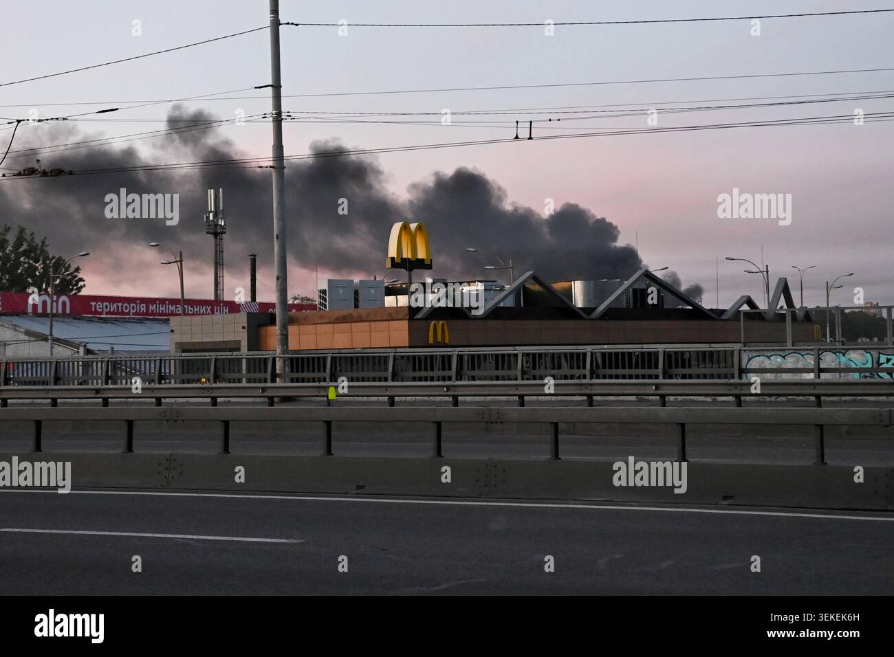 McDonald's restaurant against a backdrop of black smoke in the sky ...