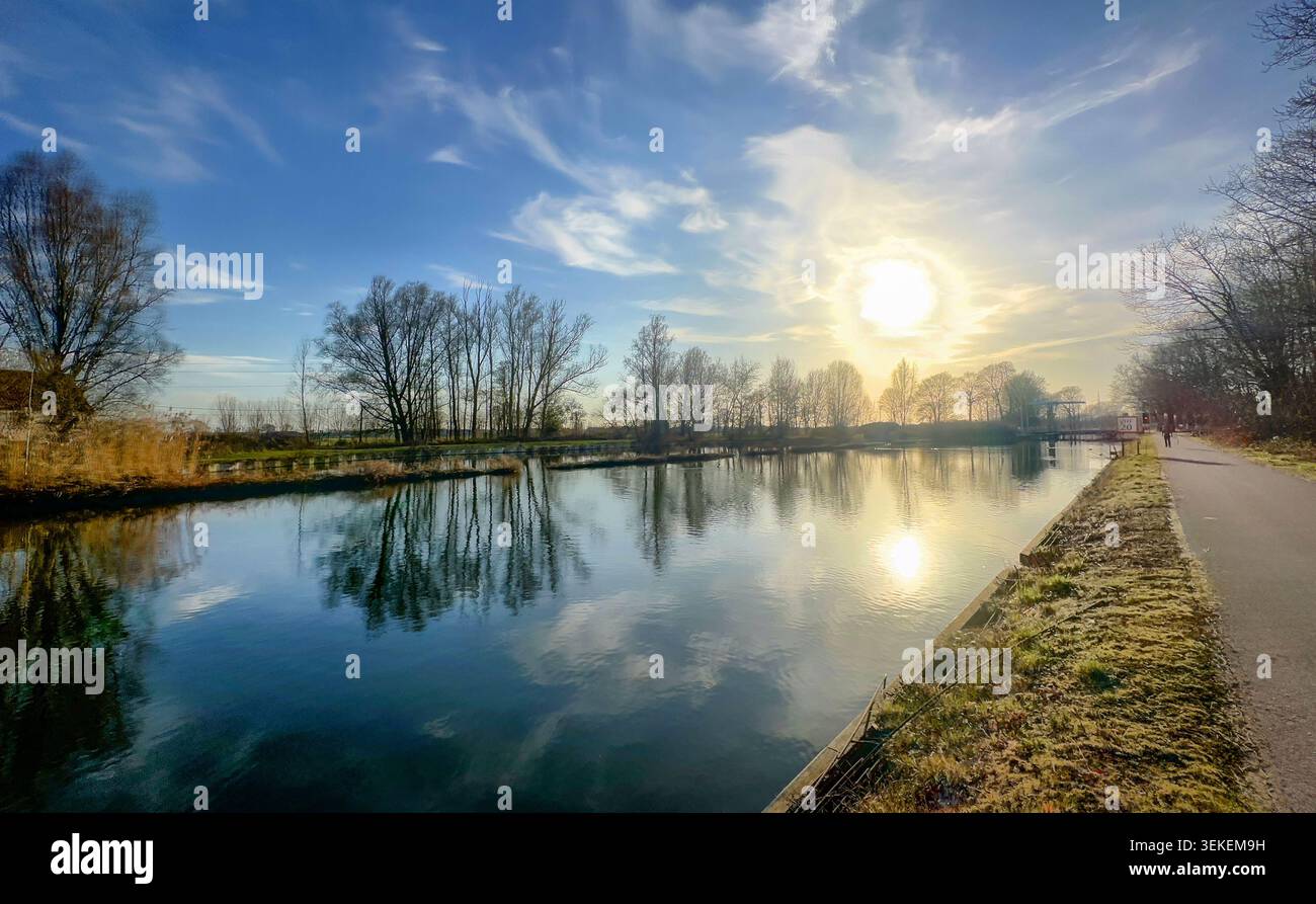 A picturesque river view at sunrise, surrounded by lush greenery ...