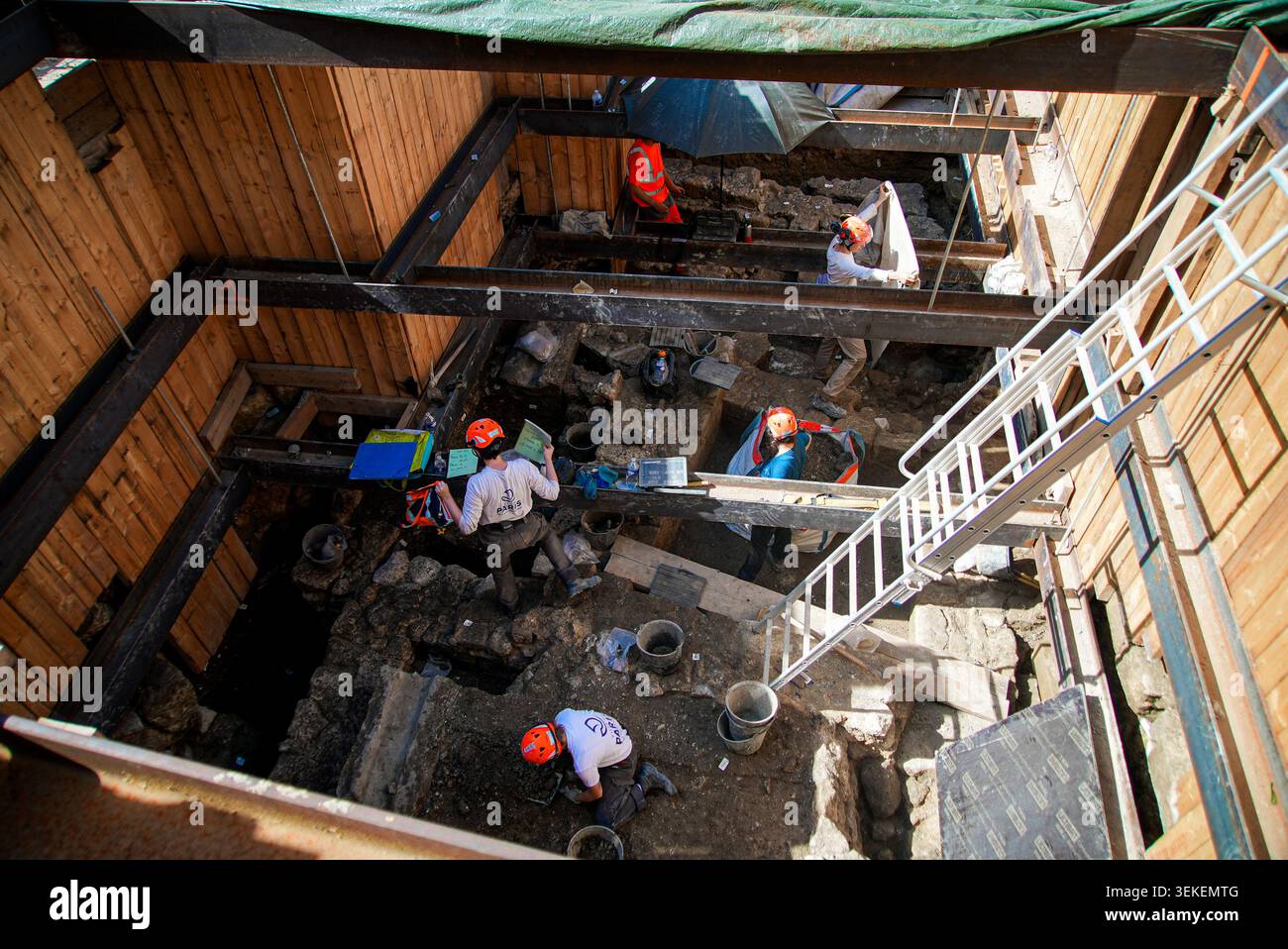 Archaeological workers wearing hard hats dig 4 meters (13 feet ...