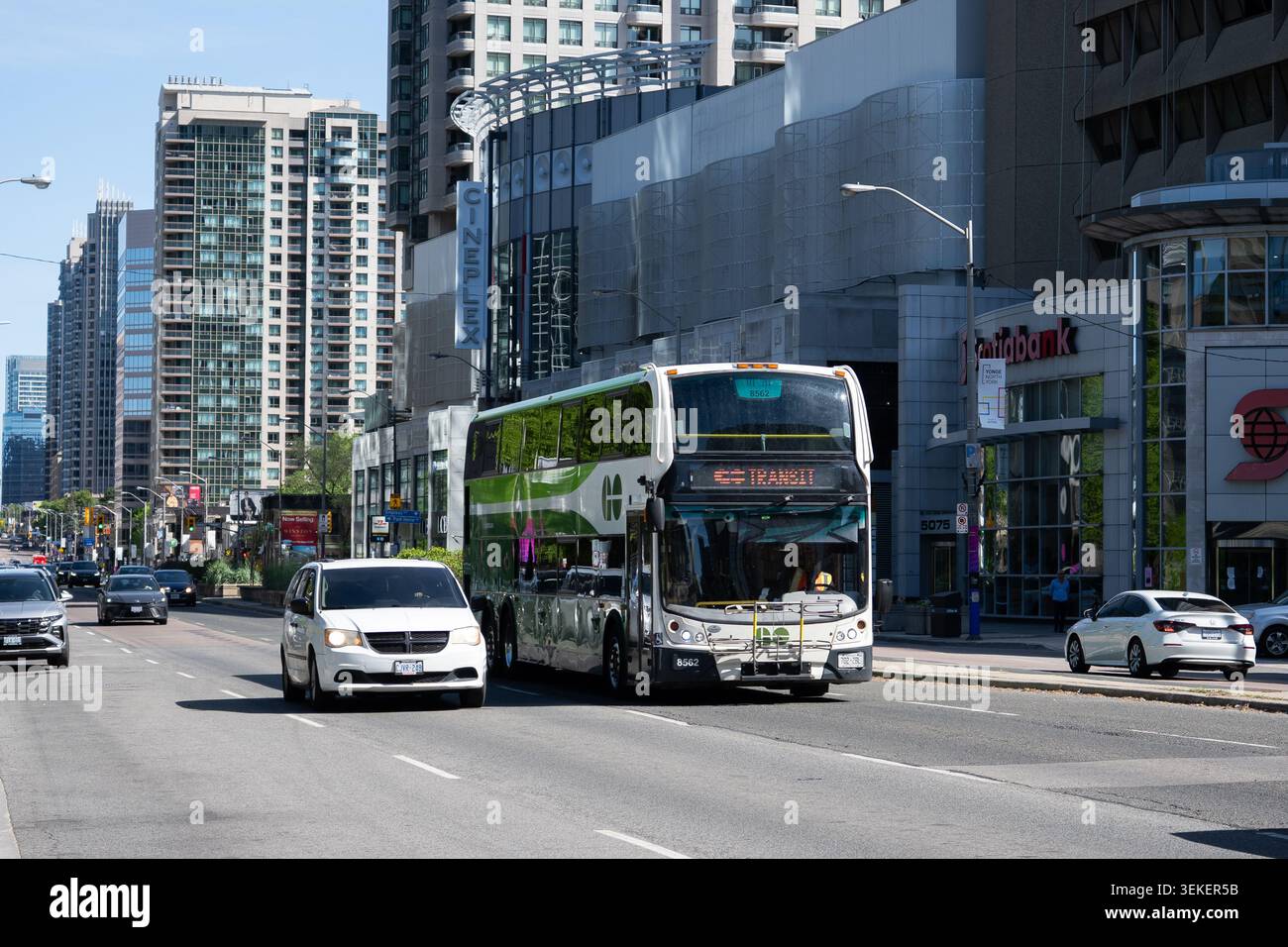A GO Transit double decker bus travels along a busy street in downtown ...