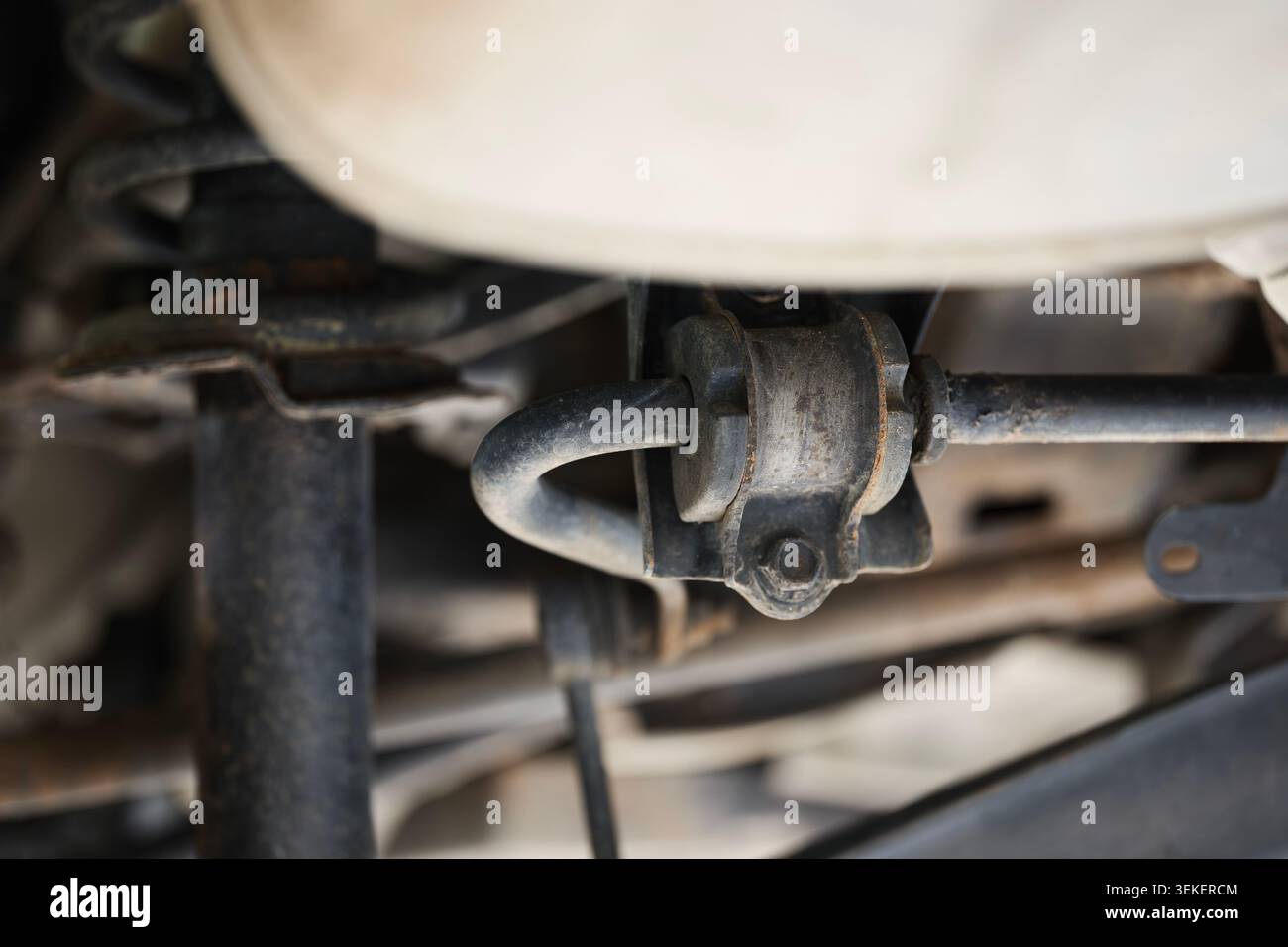 Close up of an automotive anti-roll bar with rubber bushing and bracket ...