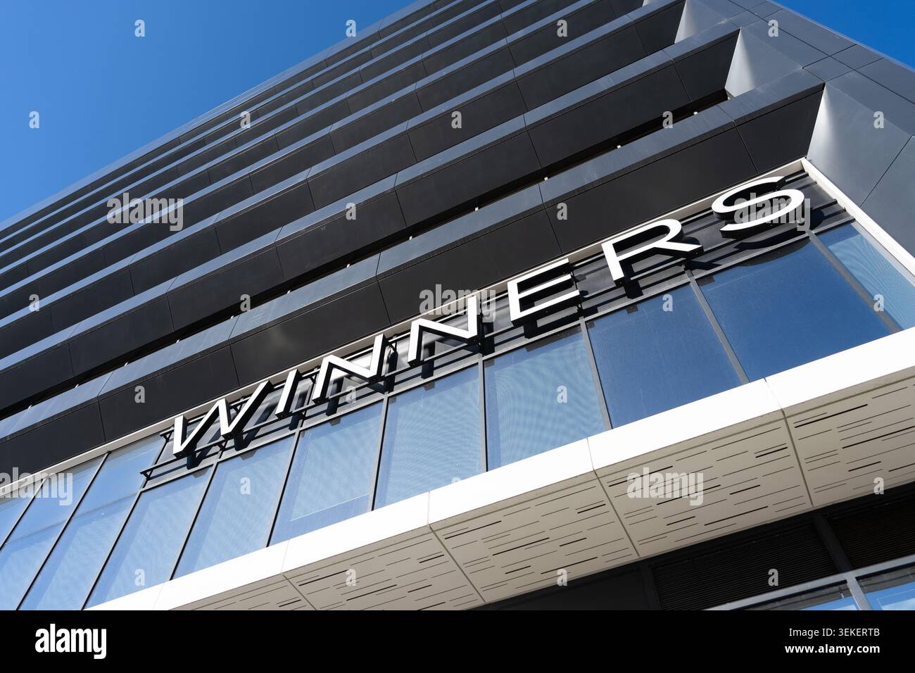 A low-angle view of a contemporary building facade featuring large ...