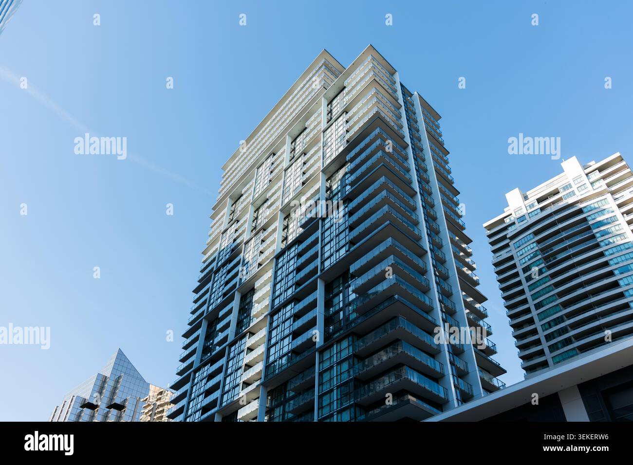 A low angle view of contemporary high rise residential towers featuring ...