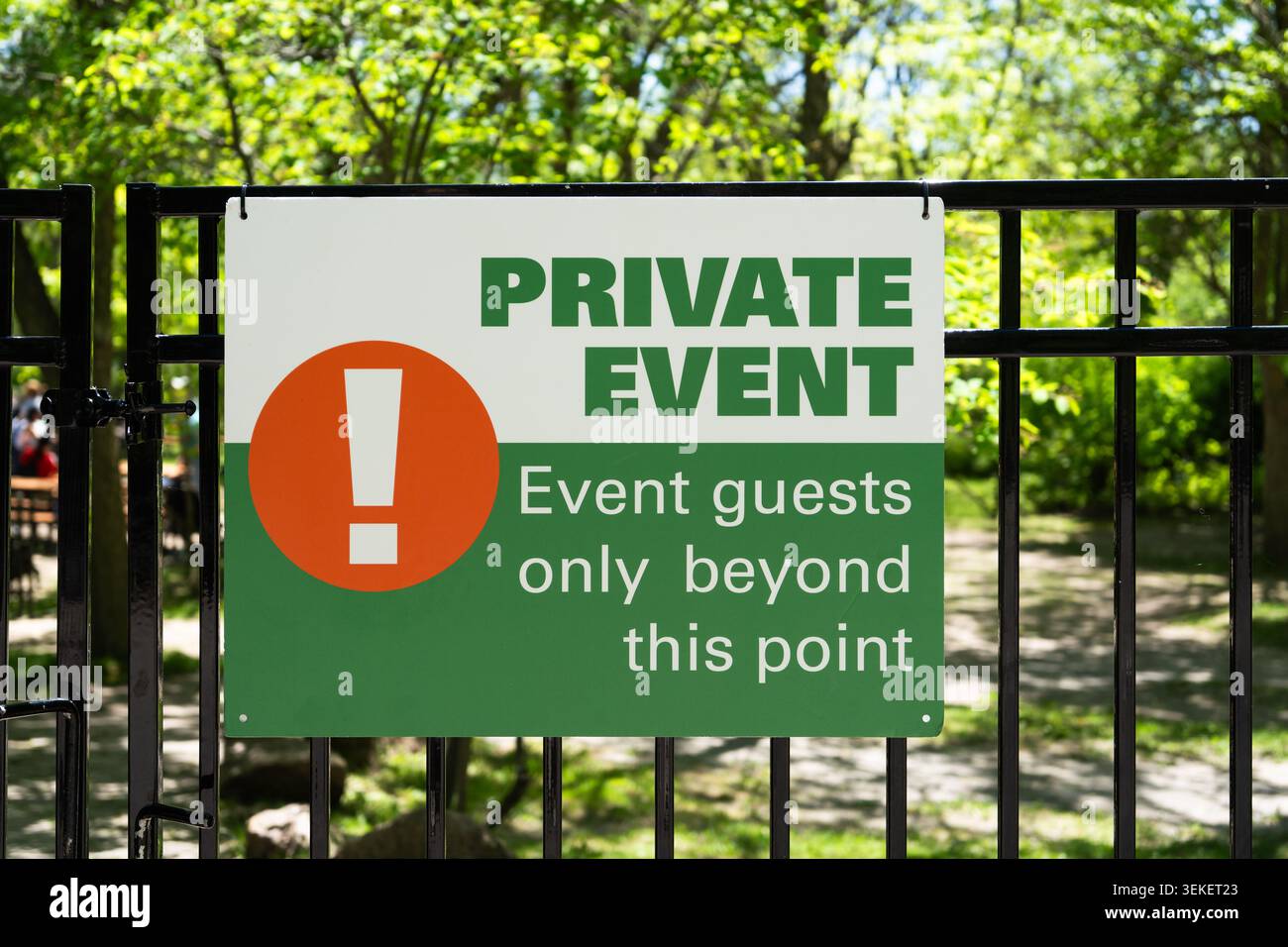 A sign on a black metal fence reads 'PRIVATE EVENT. Event guests only ...