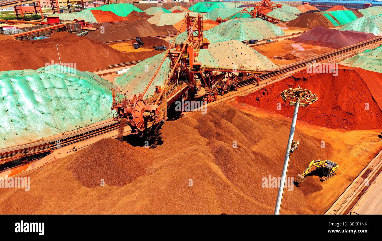 Machinery sorts and transports iron ore at Qingdao Port ore terminal in ...