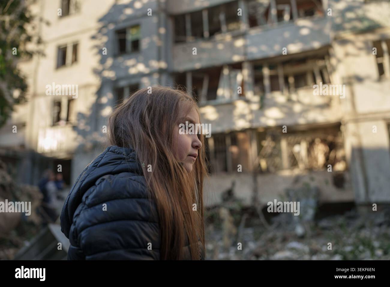Natalia Mudra, 6, stands in the yard of her house damaged after a ...