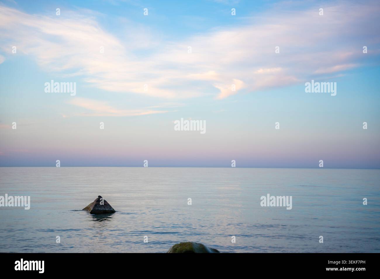 Calm sea horizon on Ruegen island in Germany during evening light over ...