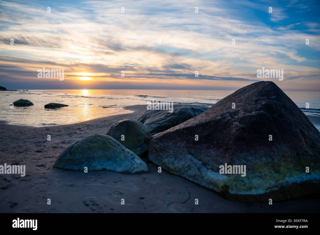 Rocky beach coastline on Ruegen island in Germany during sunset over ...