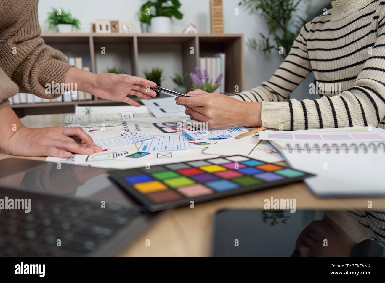 Women designers collaborating on UI UX mobile app development Stock ...