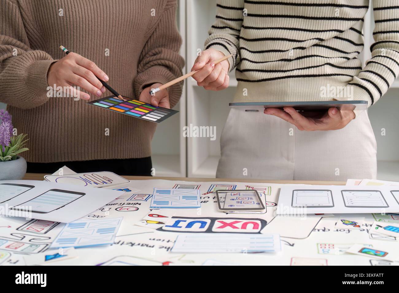 Women designers collaborating on UI UX mobile app development Stock ...