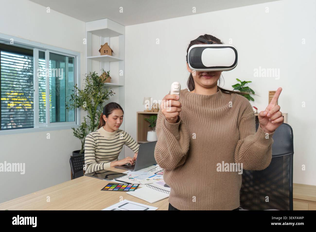 Asian woman using virtual reality headset in modern office for future ...