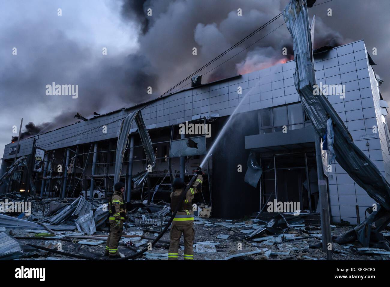 Ukrainian firefighters battle a fire at a heavily damaged commercial ...