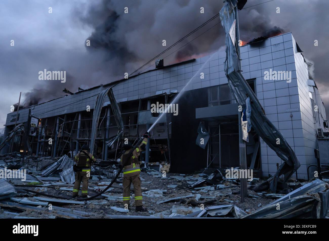 Ukrainian firefighters battle a fire at a heavily damaged commercial ...