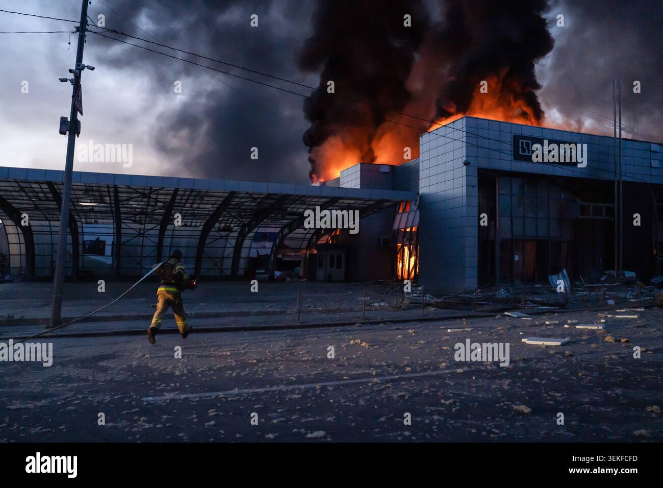 Ukrainian firefighter runs to extinguish a burning building damaged ...