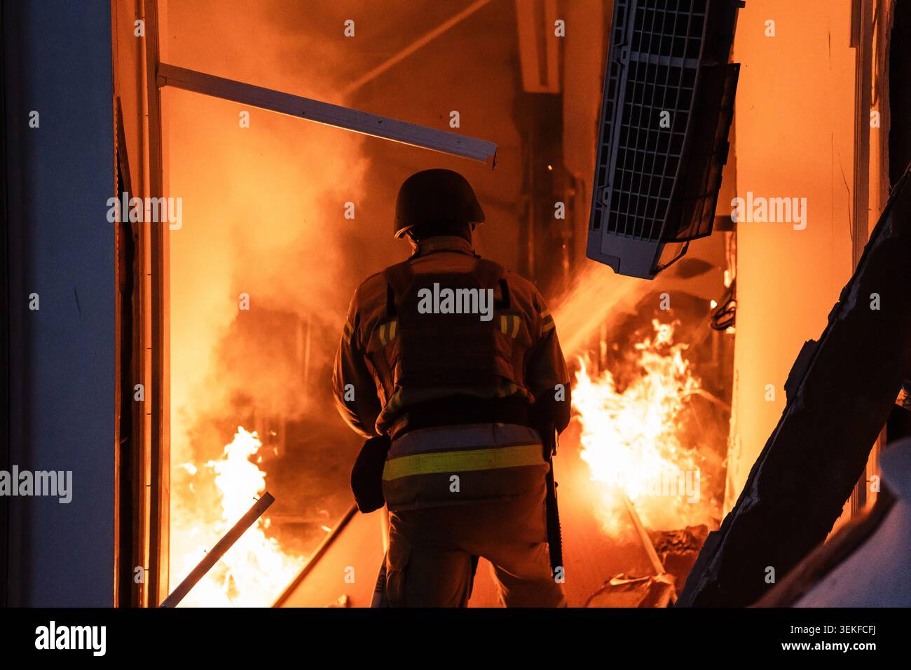 Ukrainian firefighter works to extinguish a burning commercial building ...
