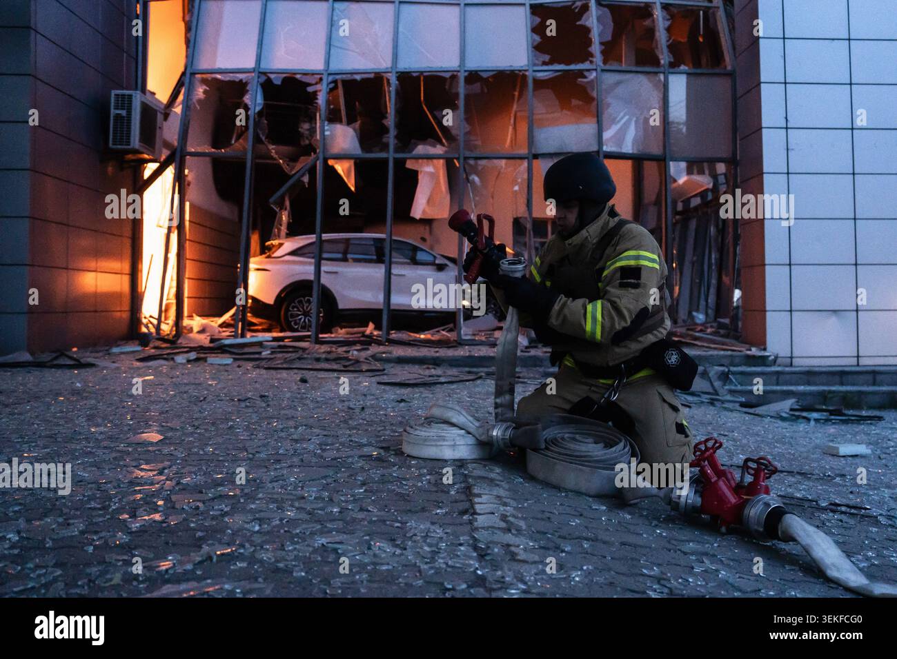 Ukrainian firefighter works to extinguish a burning commercial building ...