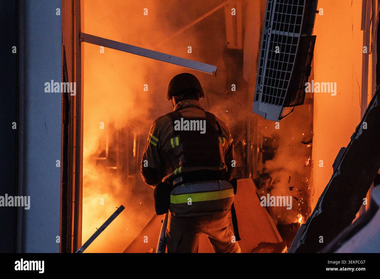 Ukrainian firefighter works to extinguish a burning commercial building ...