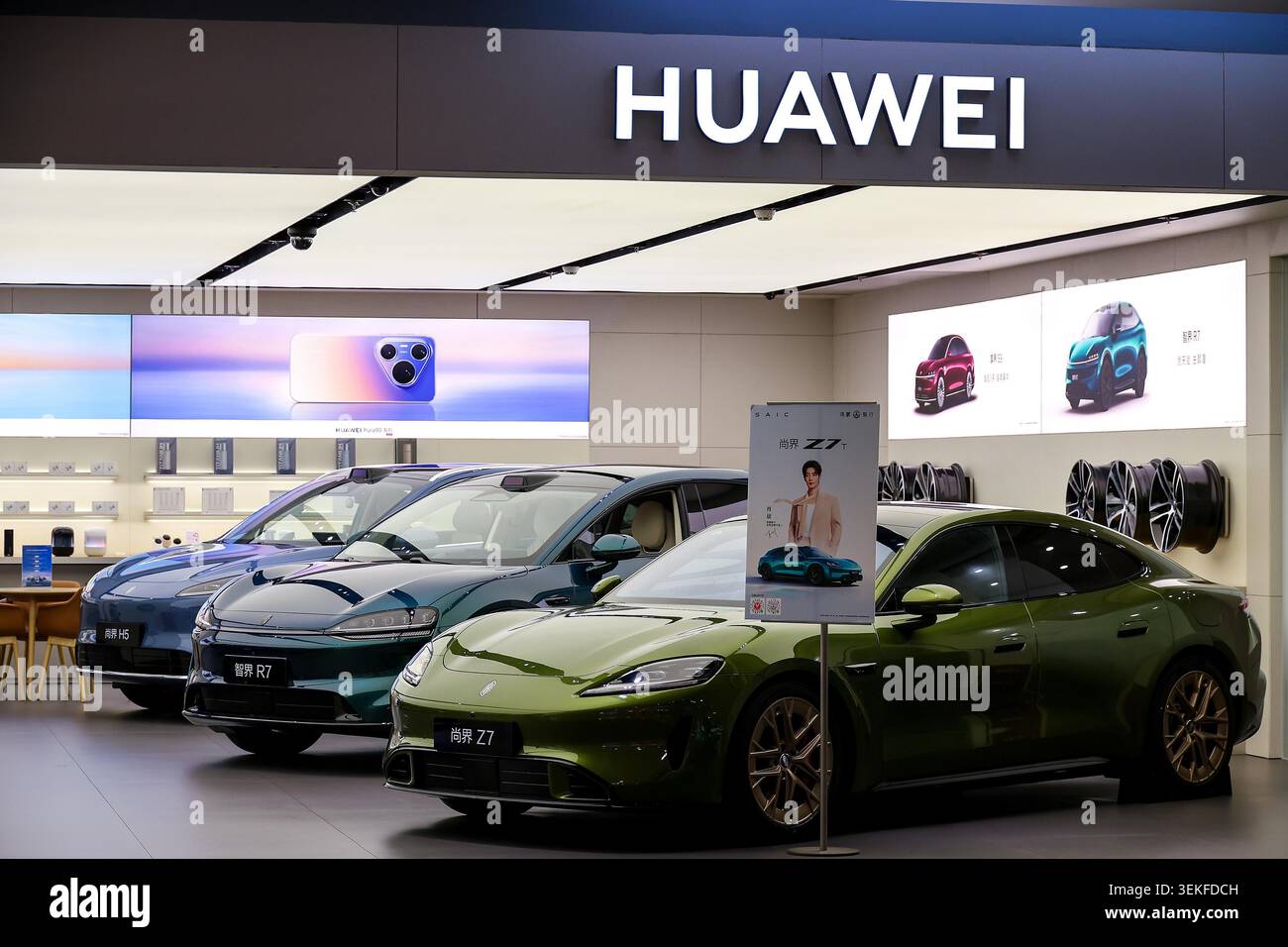 A citizen checks new energy vehicles at a Huawei Smart Driving store in ...