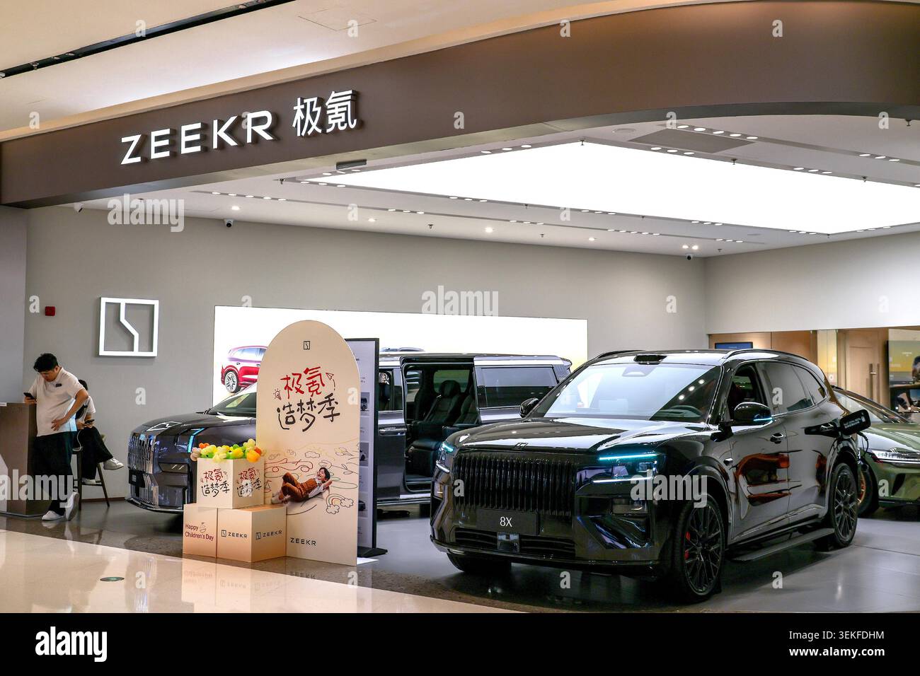 Residents check out Zeekr new energy vehicles at a shopping mall in ...