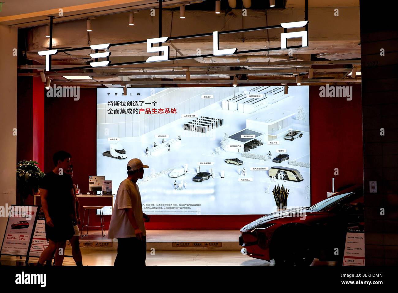 A car buyer tests a Tesla vehicle at a shopping mall in Shanghai, east ...