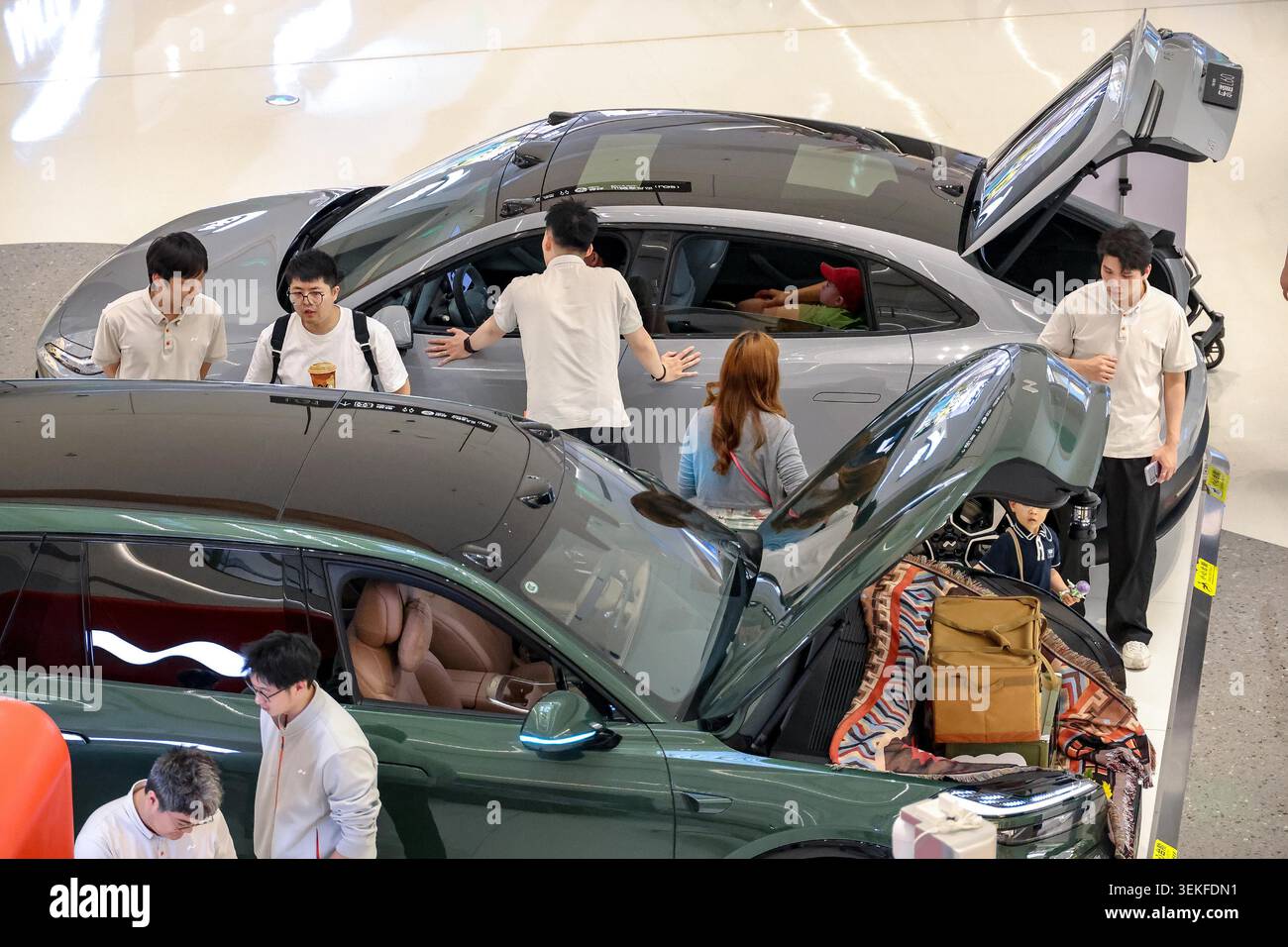 Car buyers try NIO's new energy vehicle brand Onvo at a shopping mall ...