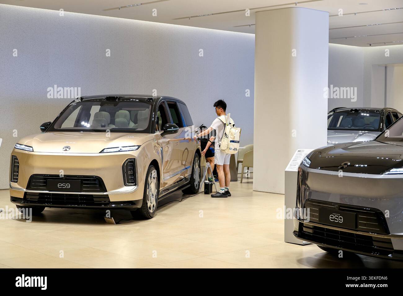 A customer test-drives a NIO electric vehicle at a shopping mall in ...
