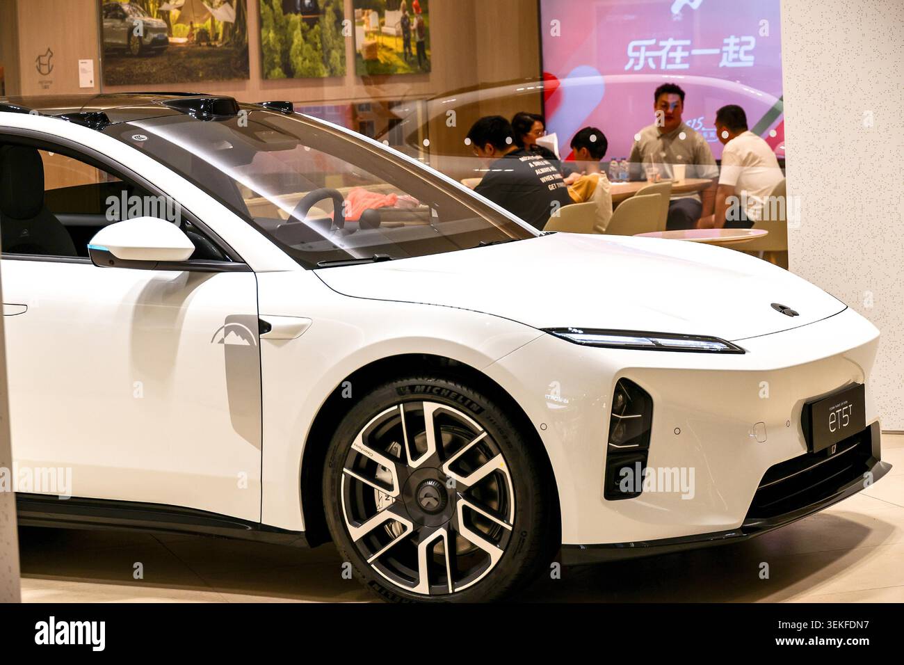 Customers experience new energy vehicles at a NIO showroom in Shanghai ...