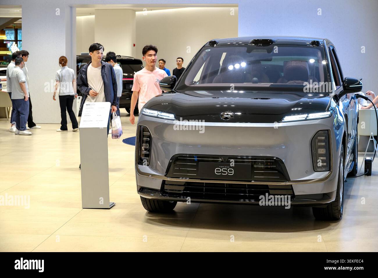 Car buyers experience NIO new energy vehicles at a shopping mall in ...