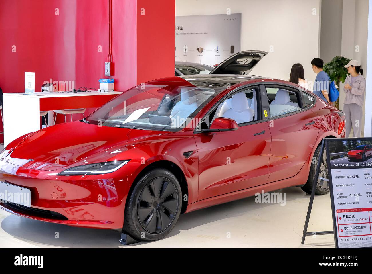 Residents experience Tesla Model 3 cars at a shopping mall in Shanghai ...