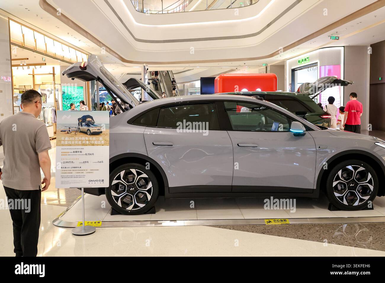 Car buyers check out NIO new energy vehicles at a shopping mall in ...
