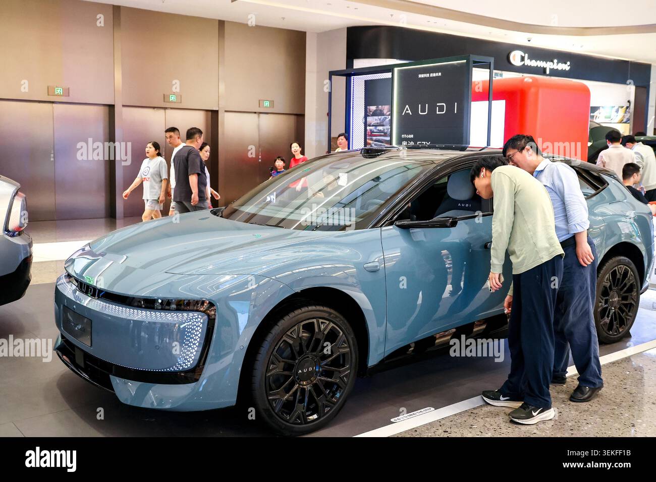Residents check out Volkswagen Audi's new energy vehicles at a Shanghai ...