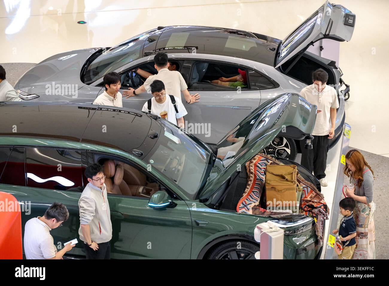 Shoppers experience NIO's new energy vehicle brand Ledo at a mall in ...