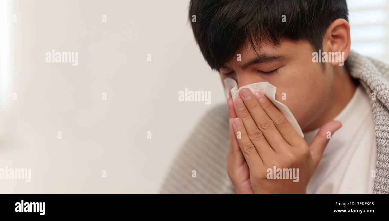 Close up Asian man blowing nose with tissue for cold and flu Stock ...