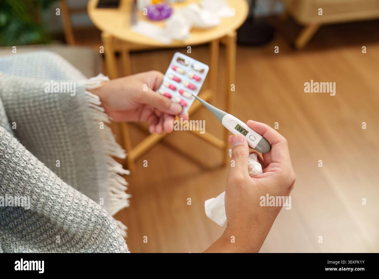 Hand holding thermometer and pills for fever and illness Stock Photo ...