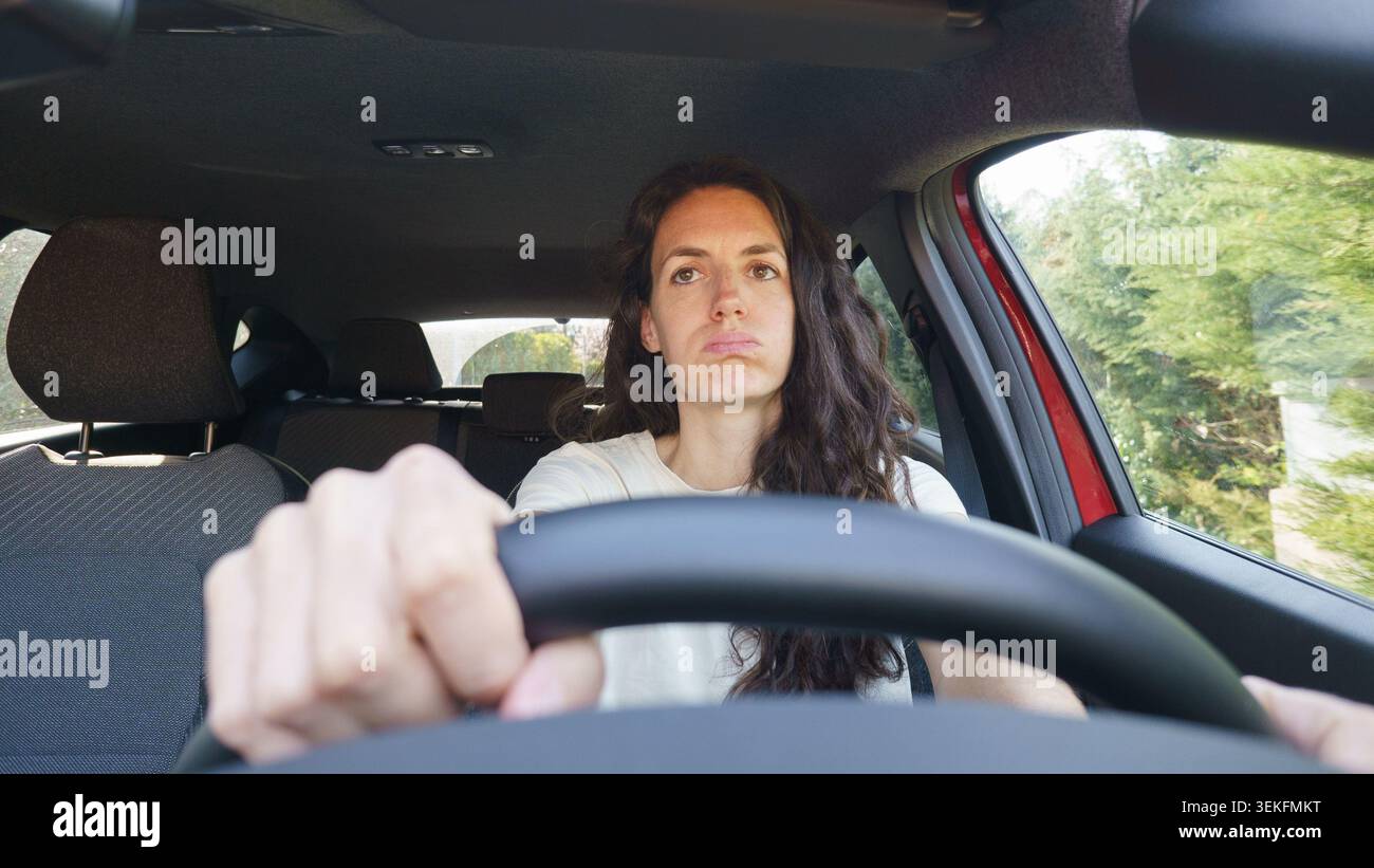 Woman feeling bored and frustrated while driving during her daily ...