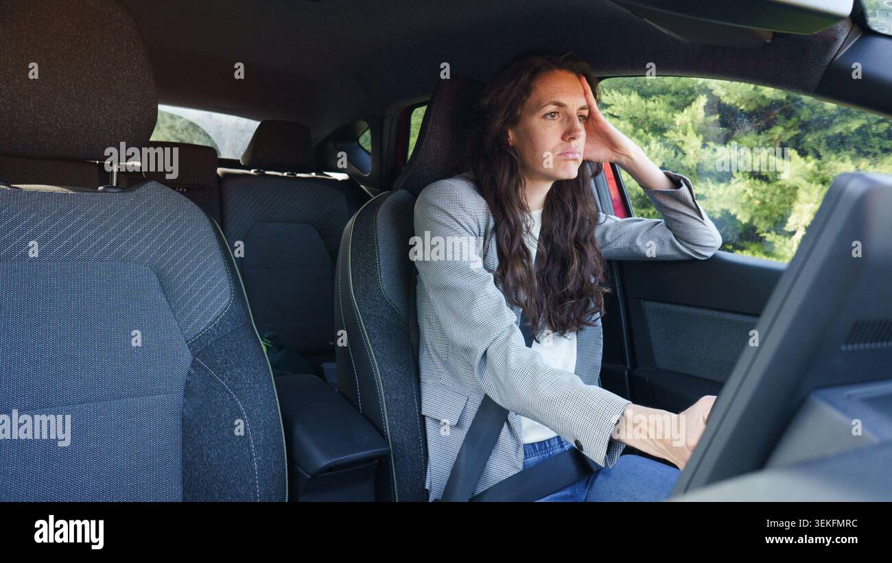 Woman feeling stressed and tired while driving or stuck in traffic ...