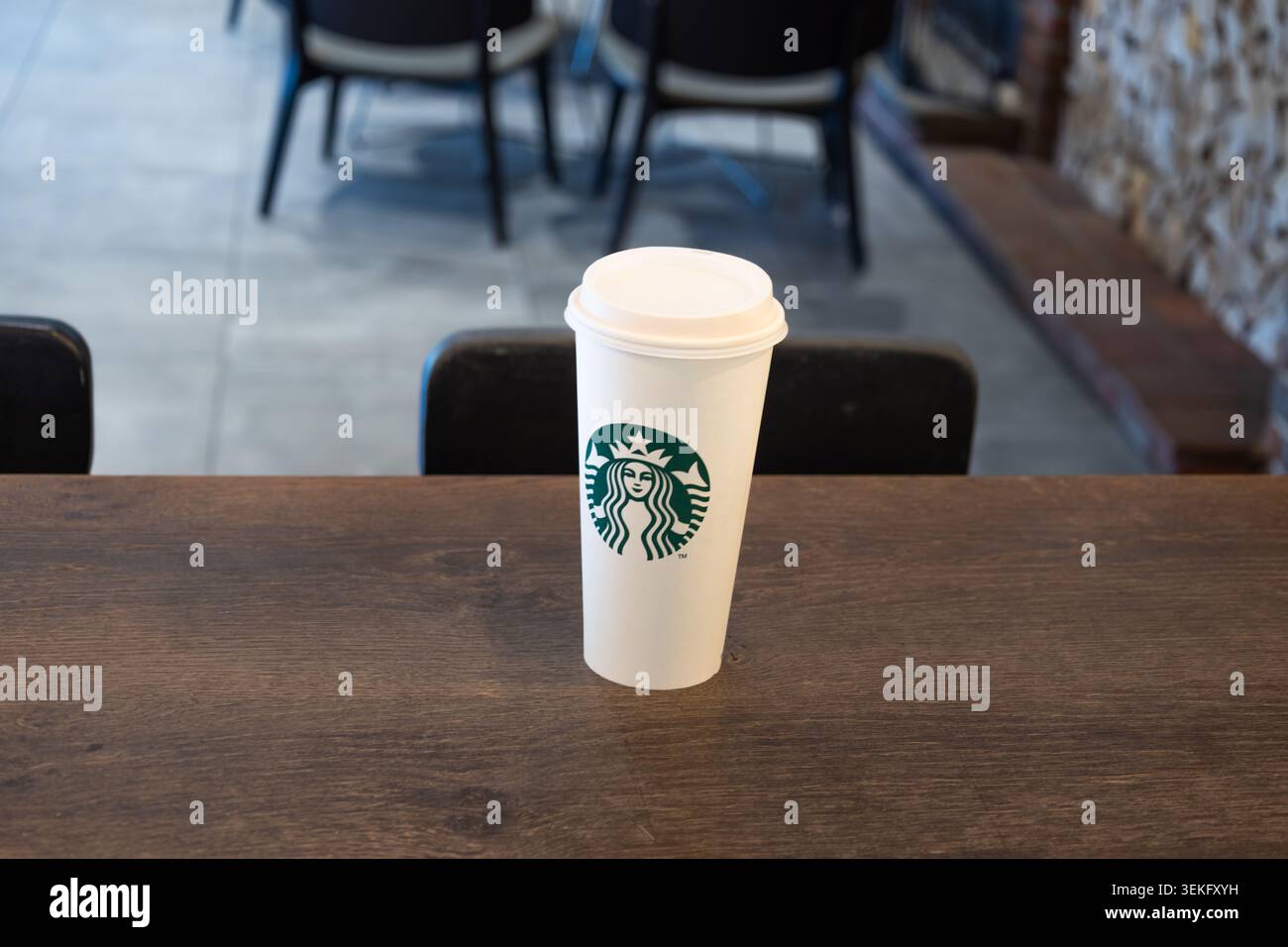 Starbucks coffee cup on a wooden table in a modern cafe interior ...