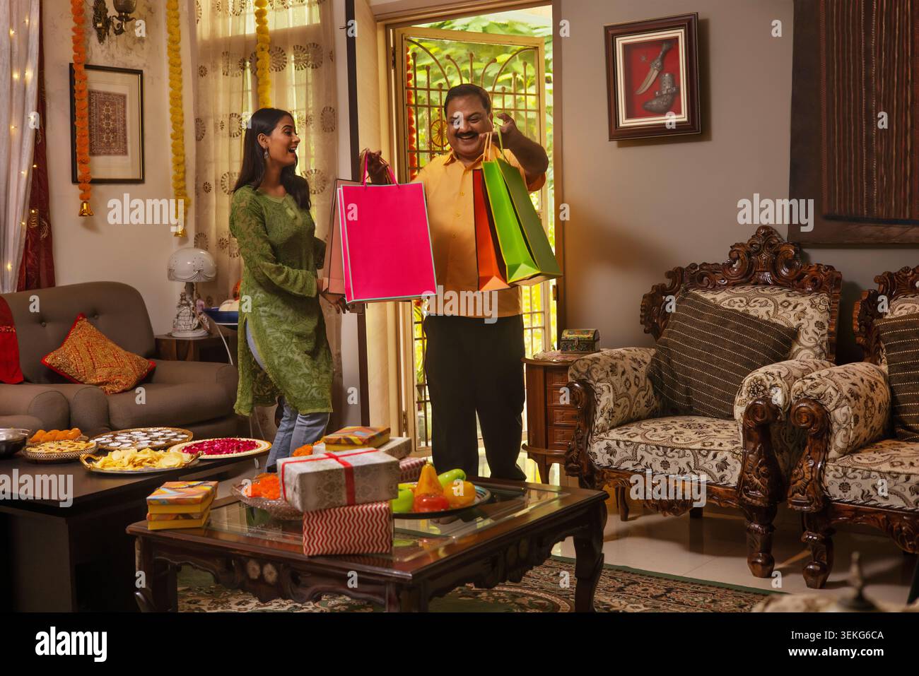 Happy man entering home with gifts purchased for his family on the ...