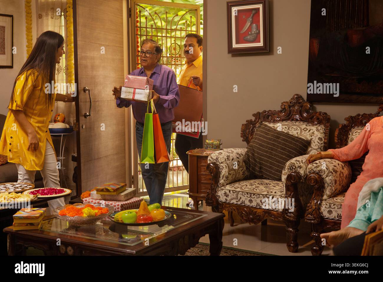 Father and son entering home with gifts purchased for their family on ...
