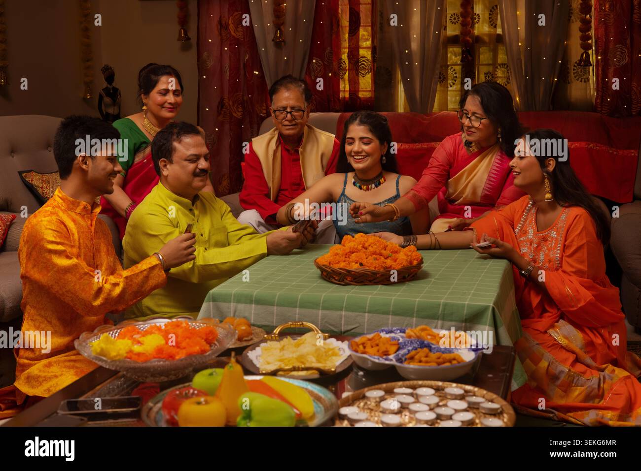Happy family in traditional outfit celebrating Diwali together at home ...