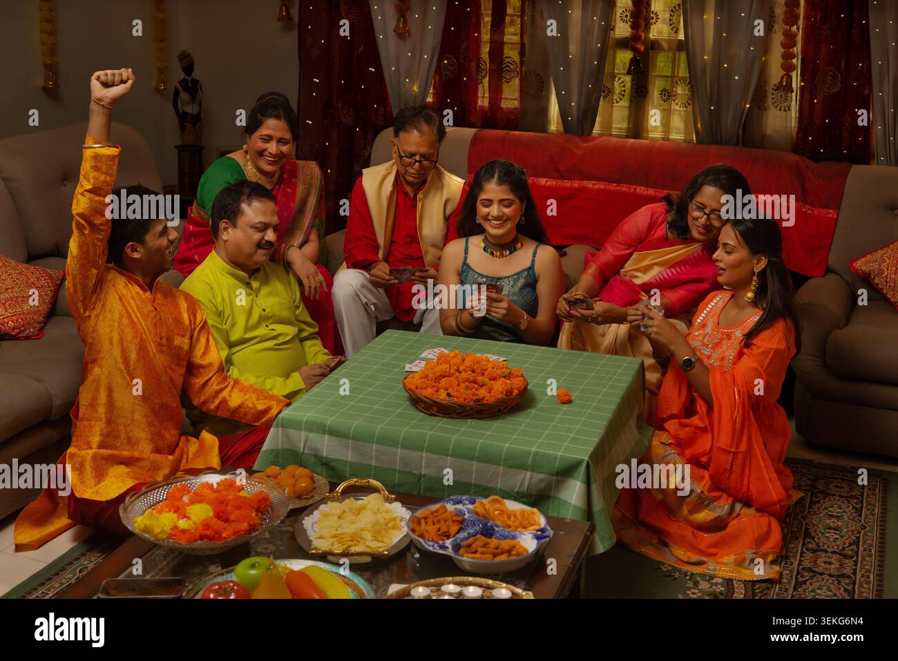 Happy family in traditional outfit celebrating Diwali together at home ...
