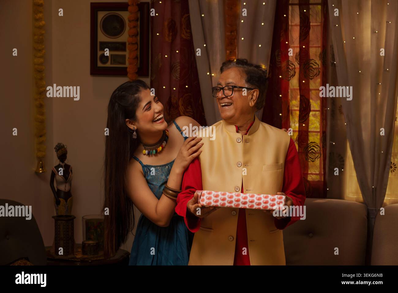 Grandfather and granddaughter sharing gift during Diwali festival Stock ...