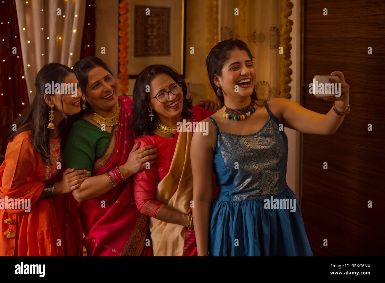 Portrait of three generation family clicking selfie together at home on ...
