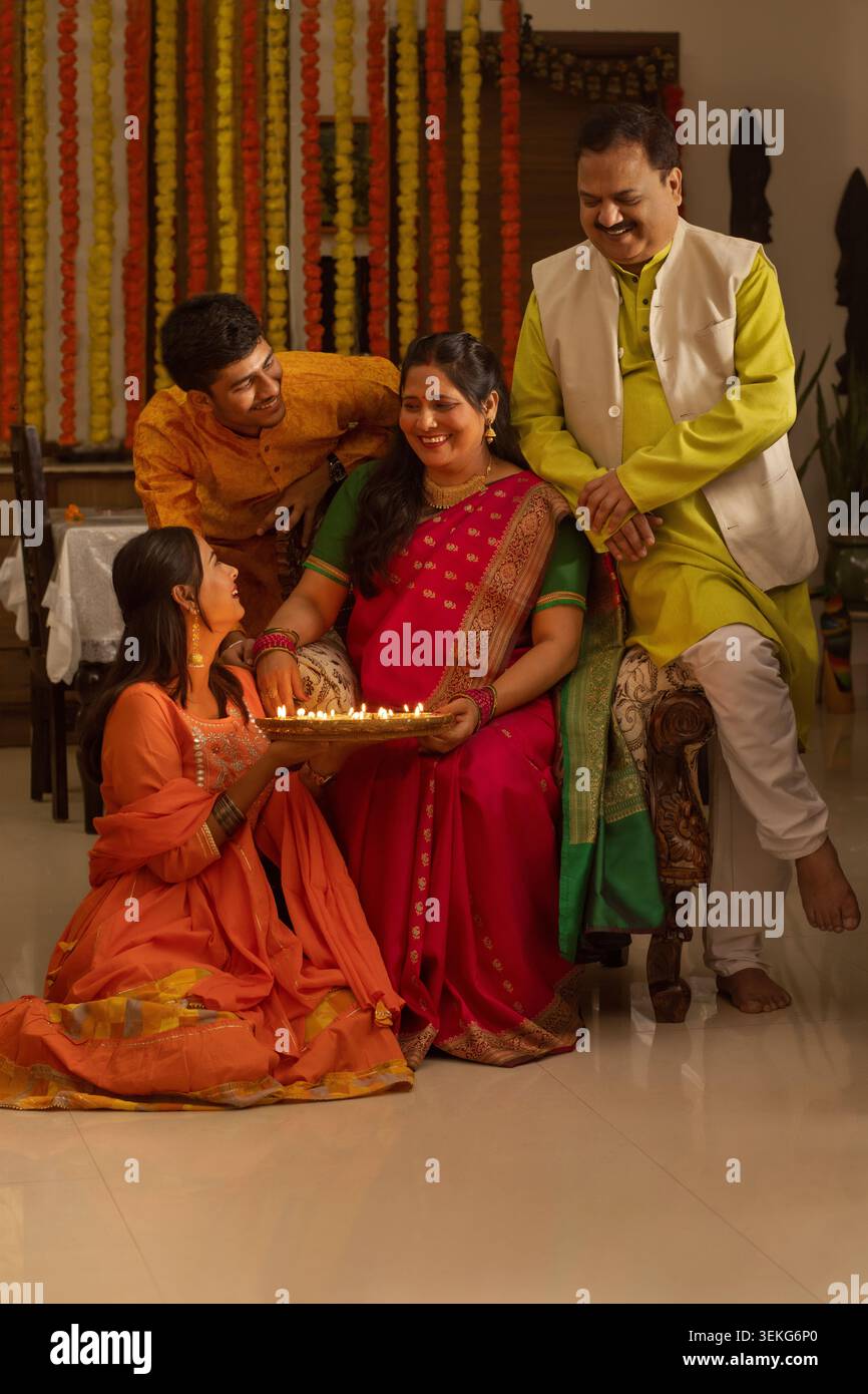 Portrait of happy Indian family celebrating Diwali together at home ...